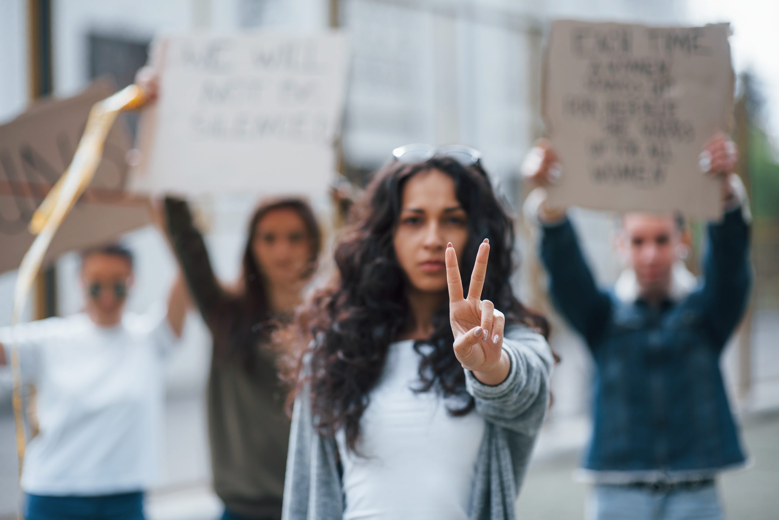 Showing gesture by two fingers. Group of feminist women have protest ...